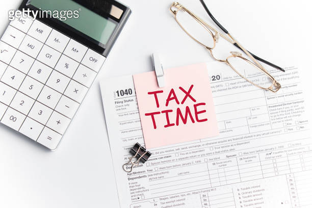 Tax forms with pen, calculator, glass and sticker. (1359416018) - 게티이미지뱅크