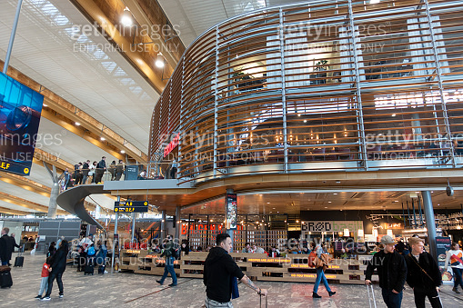 Passengers walking or dining in the terminal at Oslo Gardermoen Airport ...