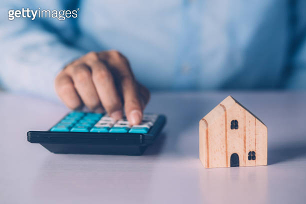 Hand of businessman planning and calculate expense and mortgage with ...