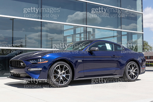 Ford Mustang display at a dealership. Ford offers the Mustang in a base ...