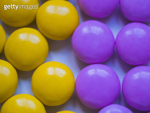 View of yellow and purple chocolate candy. Colorful background 이미지 ...