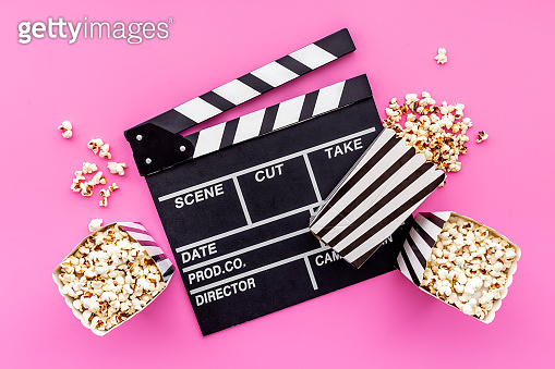 Layout of film reel with popcorn and clapperboard. Cinema concept ...