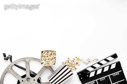 Layout of film reel with popcorn and clapperboard. Cinema concept ...