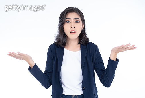 Portrait of confused and shocked young Asian business woman shrugging ...