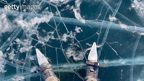 Blue transparent clear smooth ice with deep cracks. Natural landmark of ...