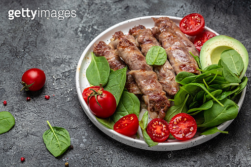 Ketogenic diet, grilled sausages minced meat wrapped in bacon with with ...