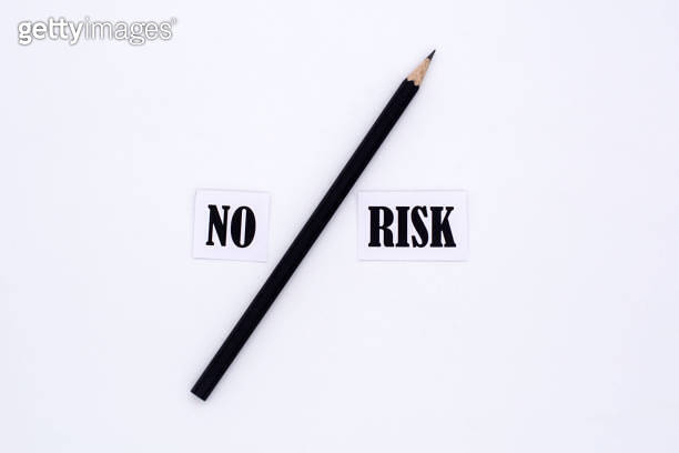 No risk words letters and a pen . Low investment risks business concept ...