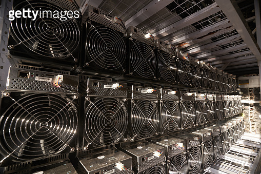 Bitcoin ASIC miners in warehouse. ASIC mining equipment on stand racks ...