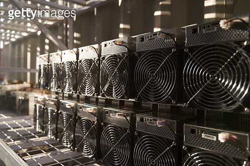 Bitcoin ASIC miners in warehouse. ASIC mining equipment on stand racks ...