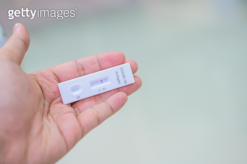 Human's hand holding Negative result shows on rapid test kit for COVID ...