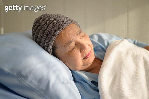 Depressed and hopeless Asian cancer patient woman wearing head scarf in ...