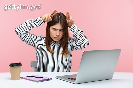 Angry bossy woman office worker holding fingers above head showing bull ...