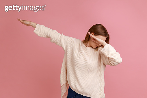 Woman showing dab dance pose, internet meme of triumph, performing ...