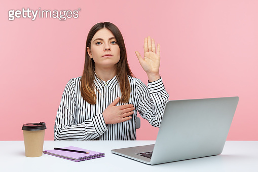 I swear! Honest dedicated woman office worker raising hand to give ...