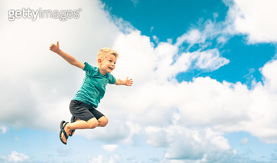 Happy little boy jumping high in the air. 이미지 (1327686612) - 게티이미지뱅크