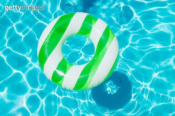 Striped Float Ring on the Surface of Crystal Clear Blue Water with ...