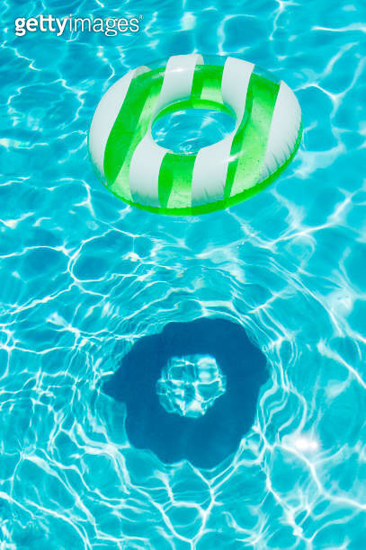 Striped Float Ring on the Surface of Crystal Clear Blue Water with ...