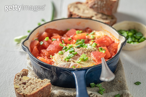 Homemade shakshuka served with bread for breakfast. Tunisian cuisine ...