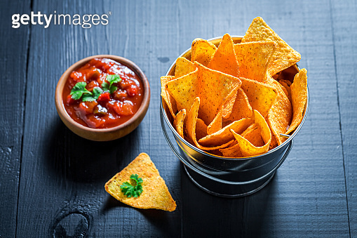 Golden nachos with tomato dip and coriander. Mexican snack. 이미지 ...