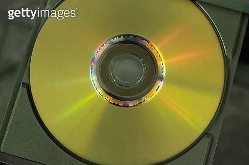 Gold DVD compact disc on the open tray of the player 이미지 (1302627527 ...