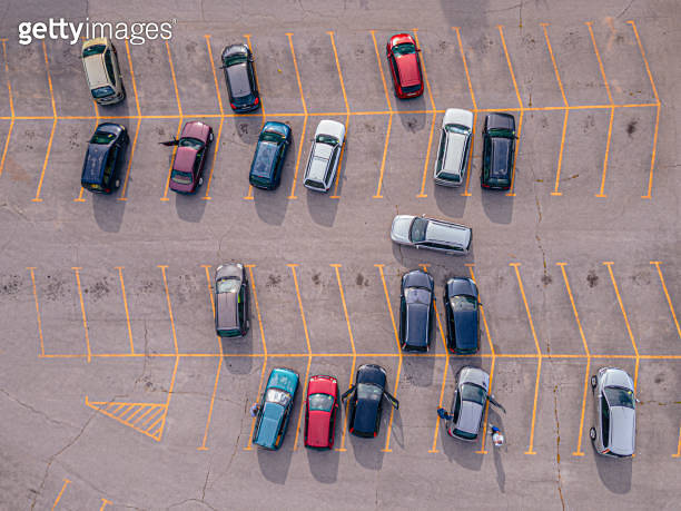 Aerial view over parking lot in the rush hour after work in a medium ...