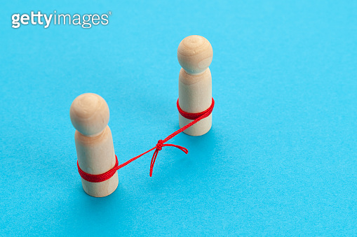 Reconciliation after a quarrel. Two figures of people are connected by ...