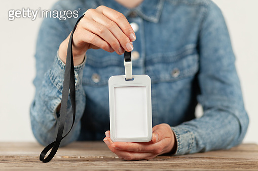 Empty identity badge in hands. Name tag template, security card mockup ...
