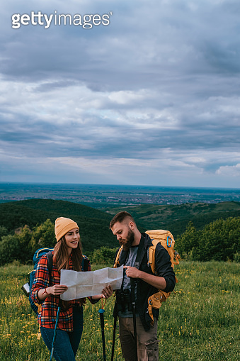Hikers using trekking poles and a map while walking in the nature 이미지 ...
