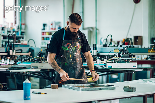 Male worker preparing screen printing film in a workshop (1357551728 ...