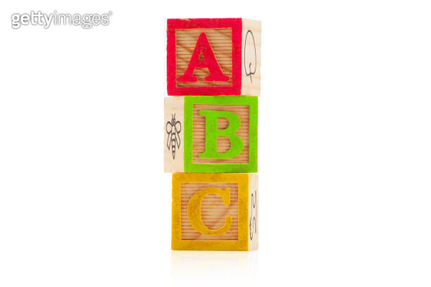 Stack of child's A B C wood blocks on white with reflection 이미지 ...