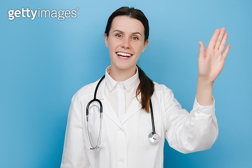 Portrait of cheerful young doctor woman wearing medical white coat and ...