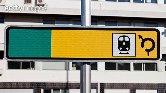 Blank yellow and green reflective road train station sign on the street ...