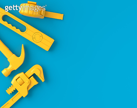Top view of monochrome construction tools for repair on blue and yellow ...