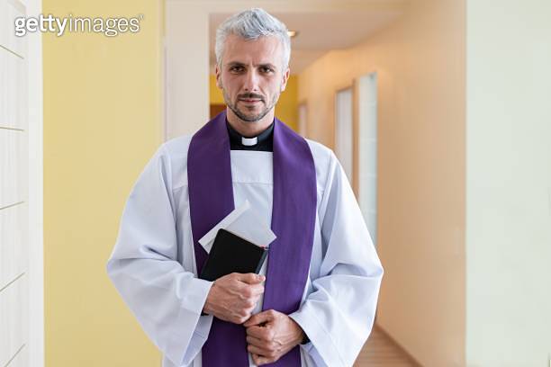 Catholic priest holding envelope with money during pastoral visit ...