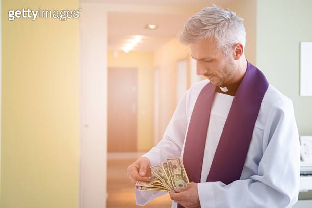 Catholic cleric priest counting american money dollar. 이미지 (1297491731 ...