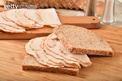 Sliced turkey on sprouted whole grain bread on a cutting board 이미지 ...