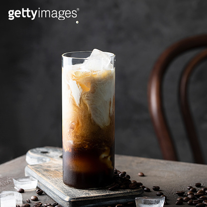 Cold brew coffee with milk shades on concrete background with coffee ...