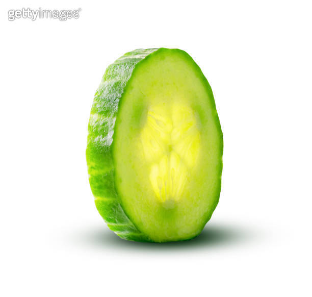 Cucumber slice with a magic glow from inside isolated on white ...