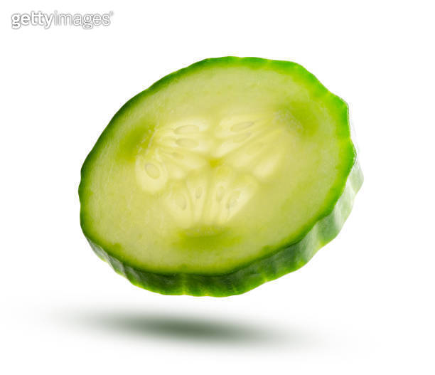 Cucumber slice with magic glow from inside isolated on white background ...