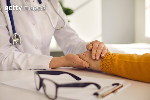 Closeup female doctor hold male patient hand give medical help support ...