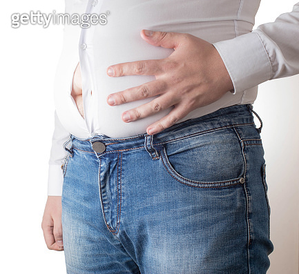 Fat man in a tight white shirt with a big belly. The concept of ...