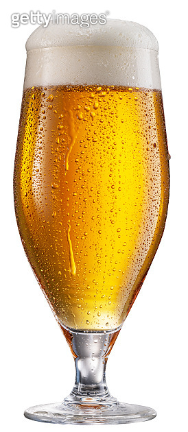 Glass of pale lager beer with water drops on cold glass surface ...
