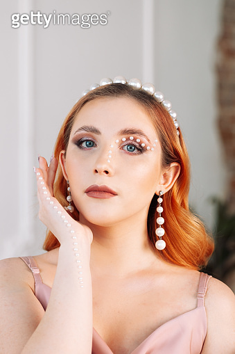 close-up portrait of a lop-eared woman in a silk dress with makeup made ...