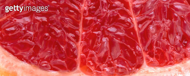 Piece of fresh grapefruit with juicy red pulp cut in half (1300876590 ...