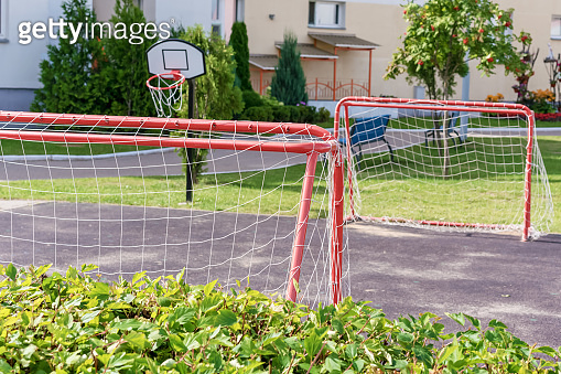 Kindergarten playground with gate for soccer and basketball backboard ...