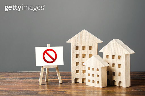 Figures of residential buildings and red prohibition sign no ...