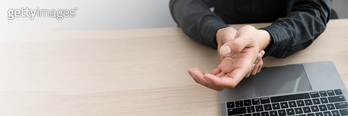 Pain from using computer. Young man holding his wrist close-up. Office ...