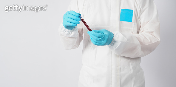 Male wear PPE suite and Hand wear latex gloves is holding blood ...
