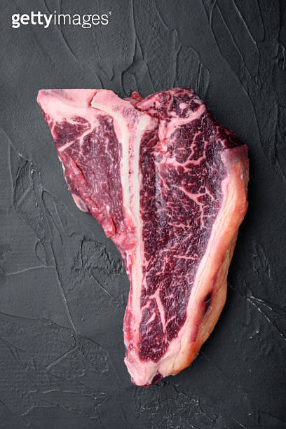 Raw meat beef steak. Black angus prime meat , T bone cut, on black ...