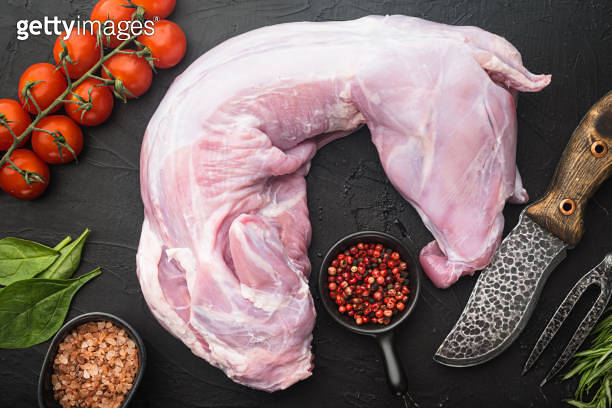 Raw and fresh meat. Whole rabbit ready to cook with ingredients, on ...
